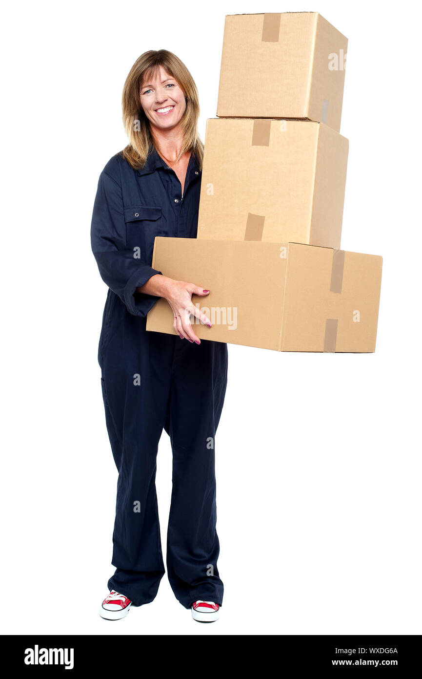 Woman in uniform carrying stack of cardboard boxes, full length ...