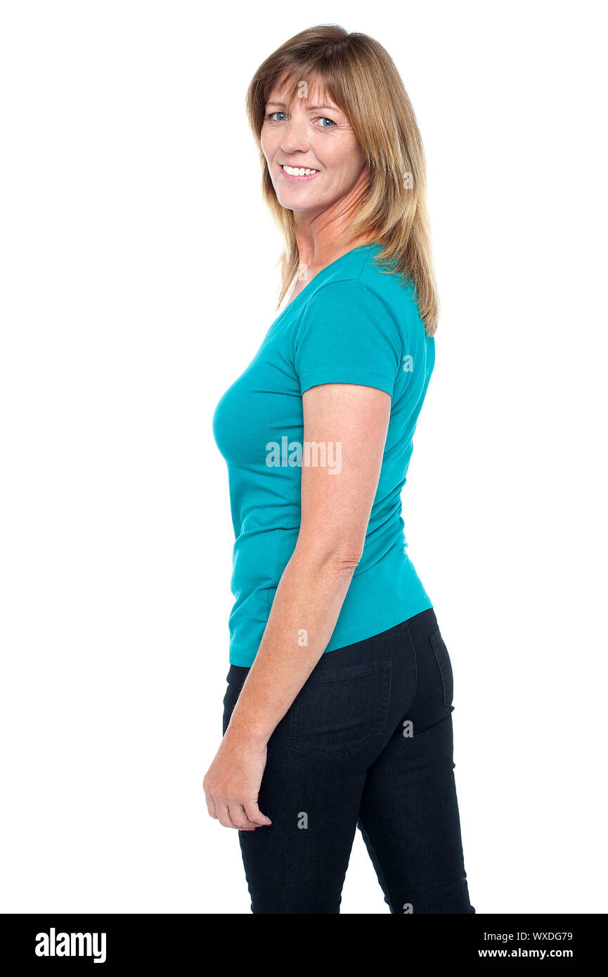 Gorgeous blonde woman turning back and smiling at you. All on white ...