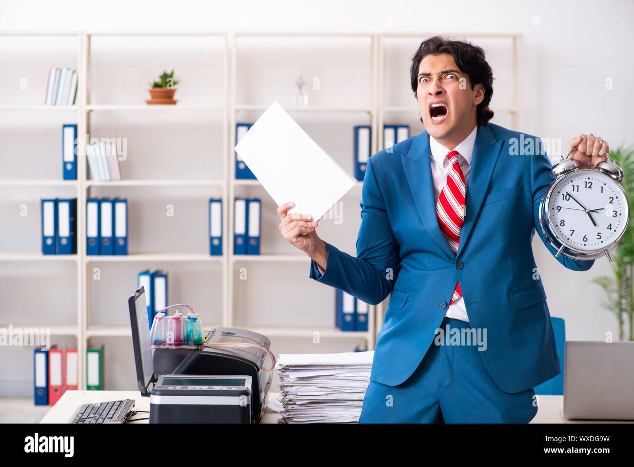 Young employee making copies at copying machine Stock Photo - Alamy