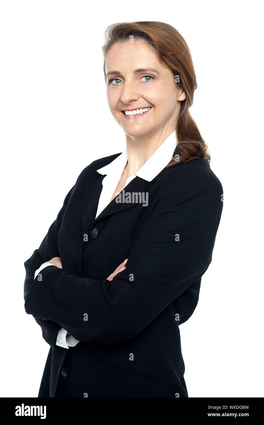 Pretty business executive posing sideways with folded arms on white ...