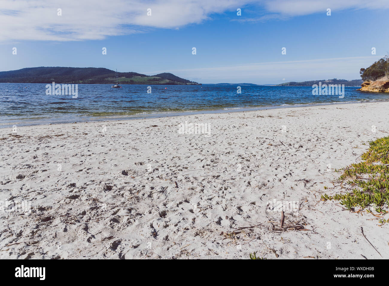 view of Conningham Beach in Tasmania, Australia with sunshine and no ...
