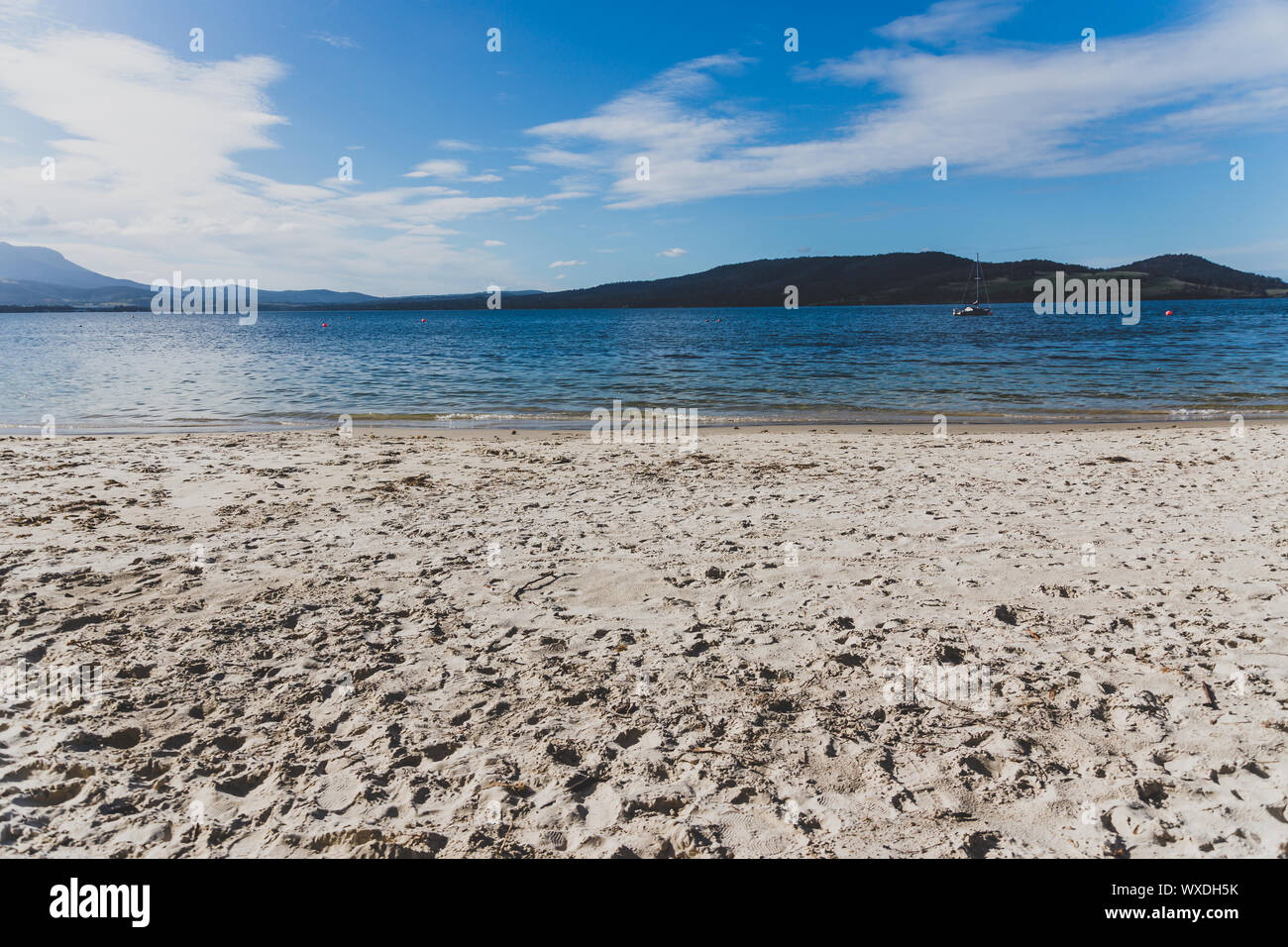 view of Conningham Beach in Tasmania, Australia with sunshine and no ...