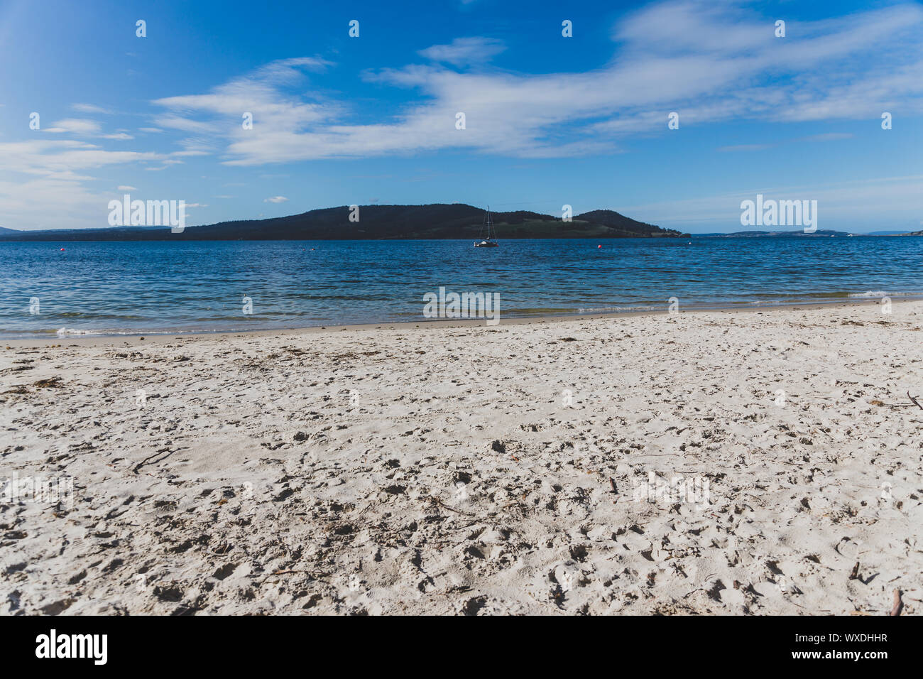 view of Conningham Beach in Tasmania, Australia with sunshine and no ...