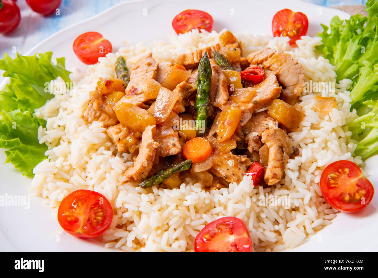 Turkey fricassee on rice with asparagus and paprika Stock Photo - Alamy
