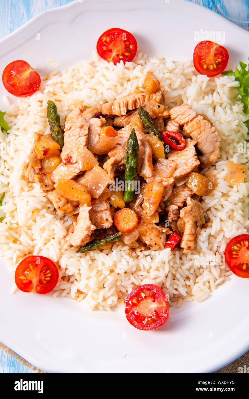Turkey fricassee on rice with asparagus and paprika Stock Photo - Alamy