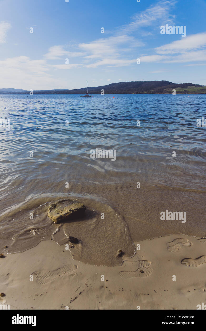 view of Conningham Beach in Tasmania, Australia with sunshine and no ...