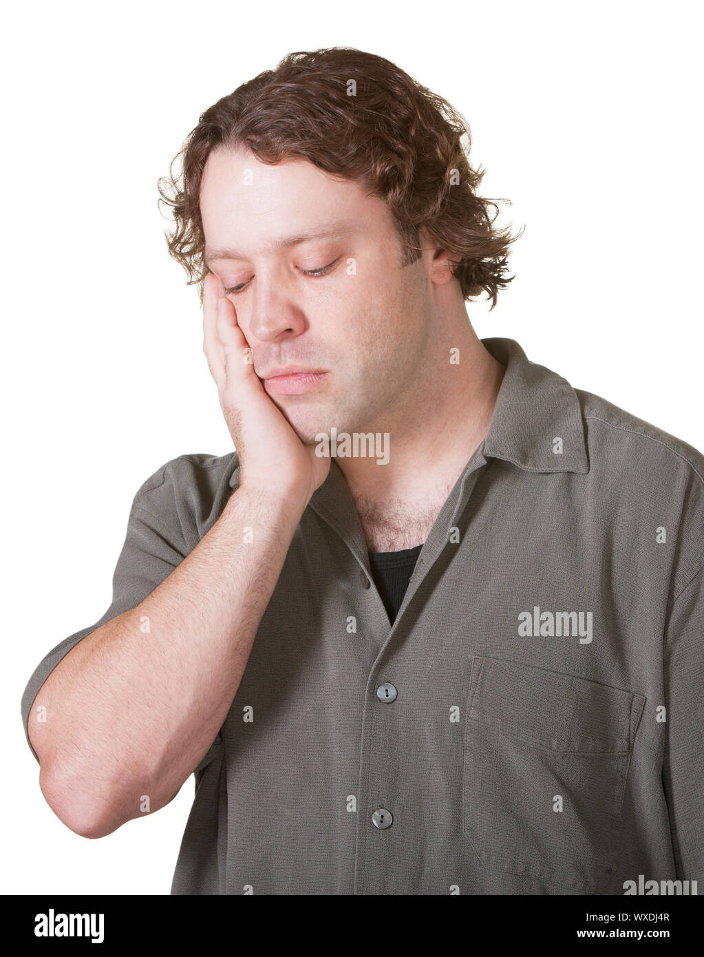 Sad Caucasian male with hand on cheek looking down Stock Photo - Alamy