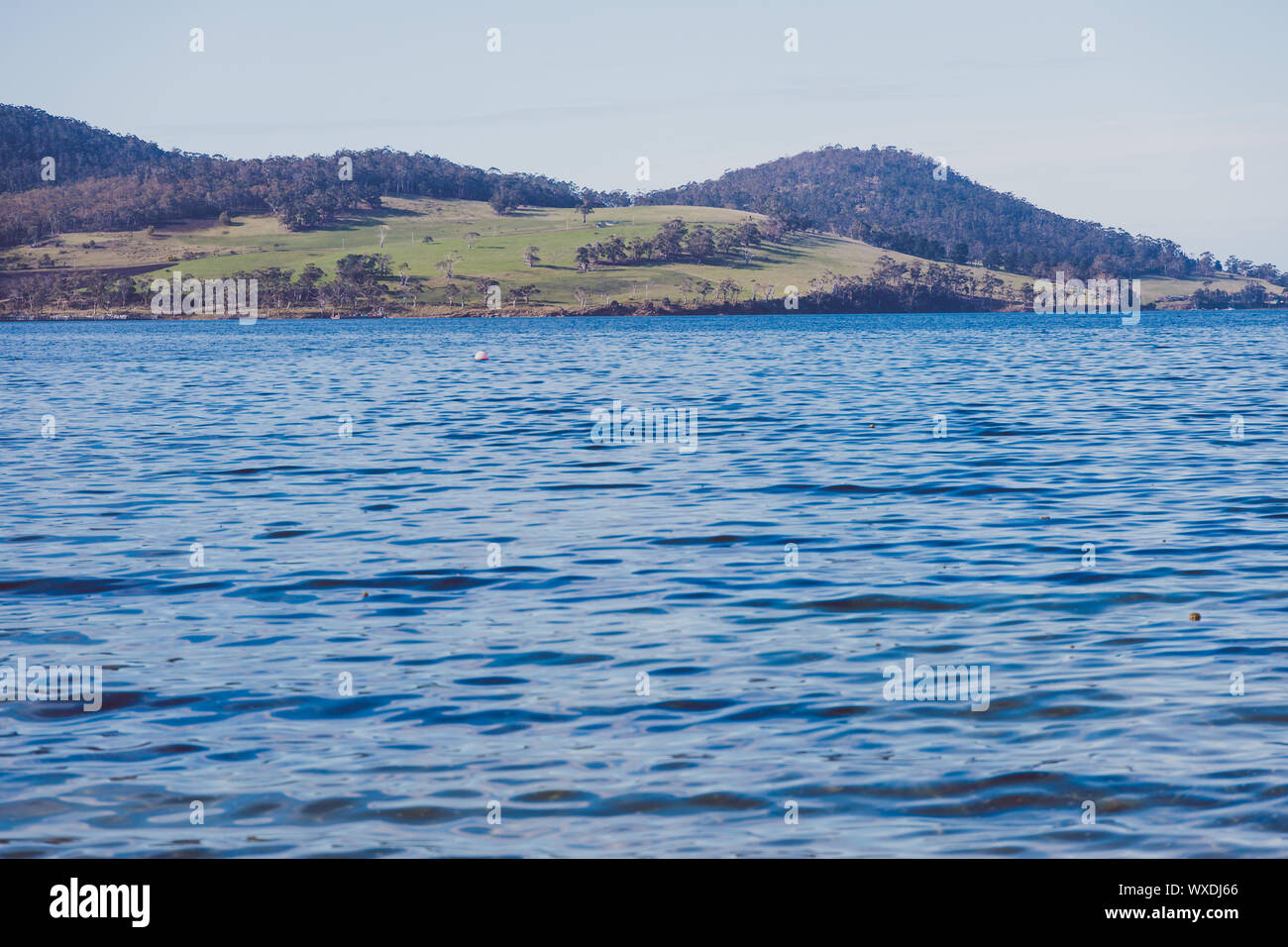 view of Conningham Beach in Tasmania, Australia with sunshine and no ...