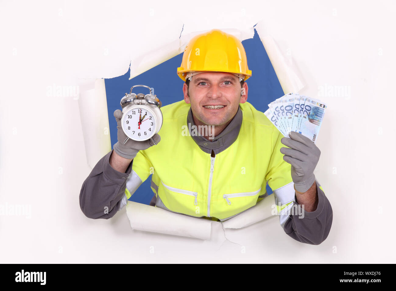 Construction worker holding clock hi-res stock photography and images ...