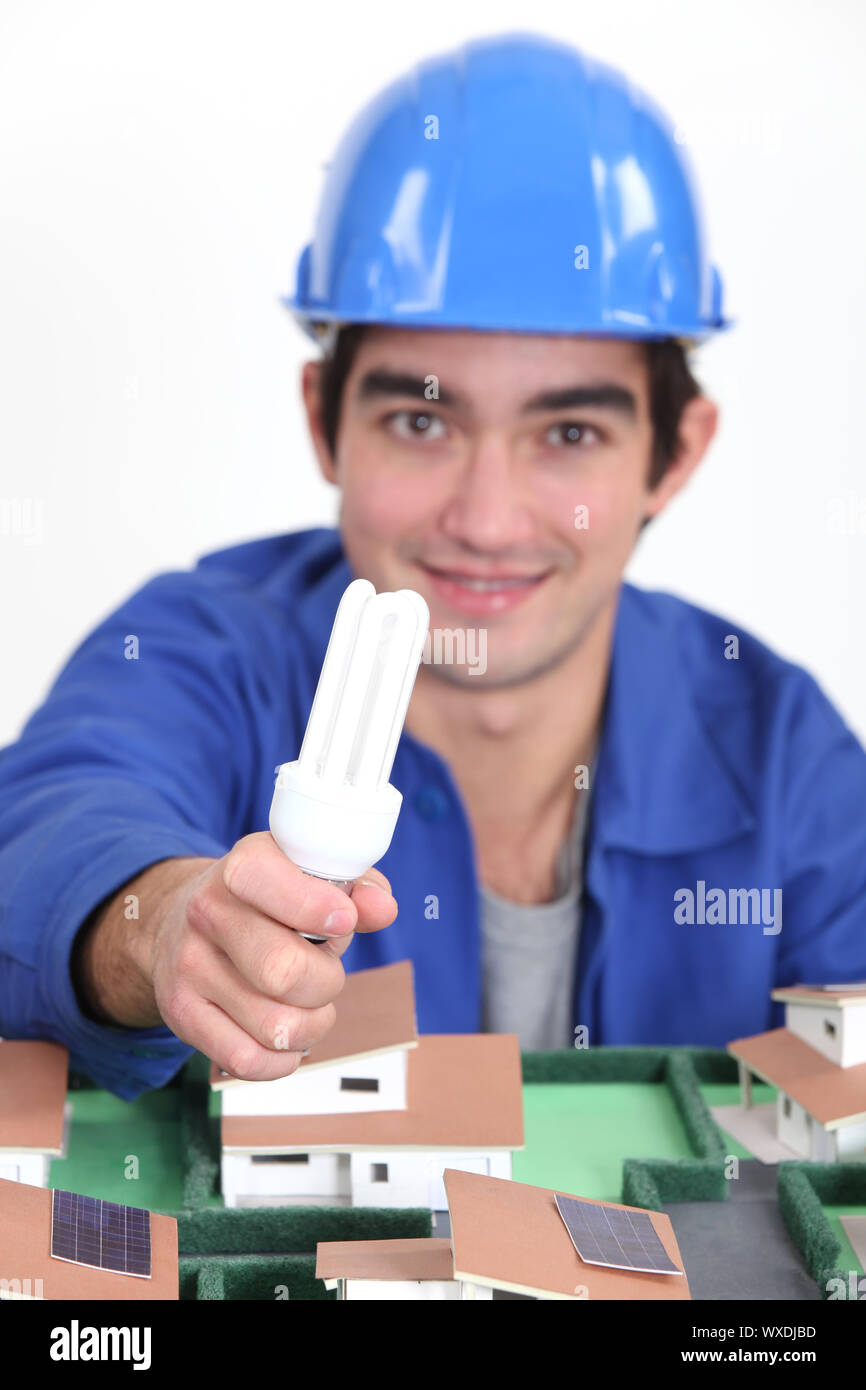 Tradesman holding a fluorescent lamp Stock Photo - Alamy