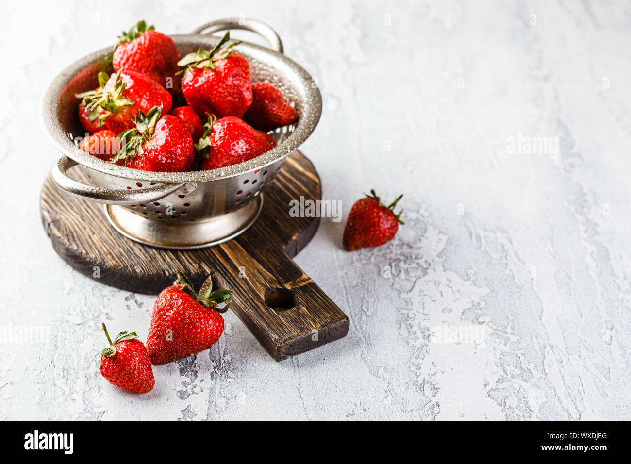 Strawberry in a colander hi-res stock photography and images - Alamy