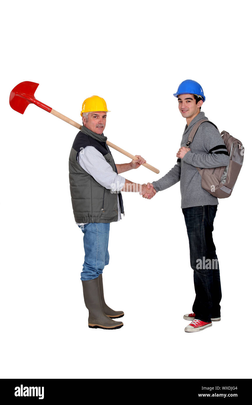 Construction workers handshaking Stock Photo - Alamy