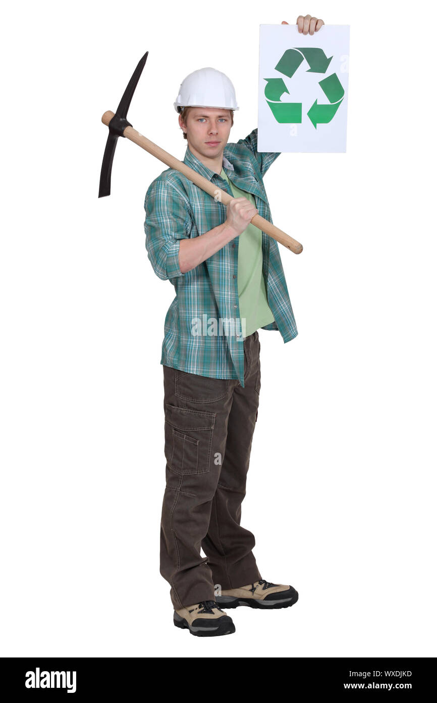 Man with pick-axe holding recycle logo Stock Photo - Alamy