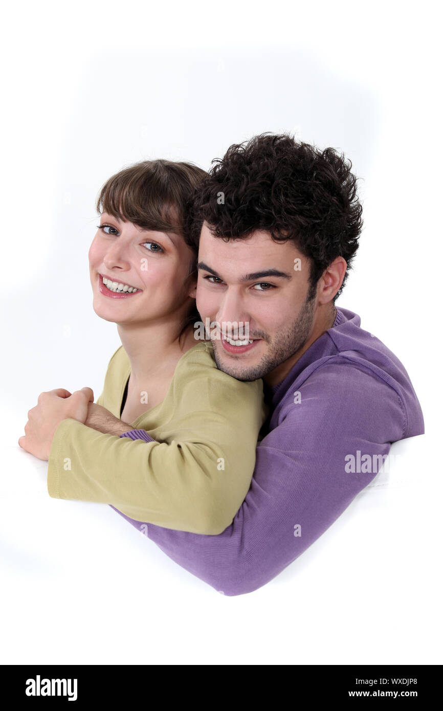 A loving young couple cuddling Stock Photo - Alamy
