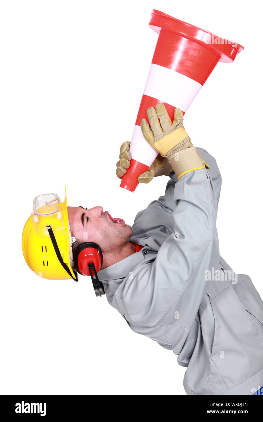Angry tradesman yelling into a megaphone Stock Photo - Alamy
