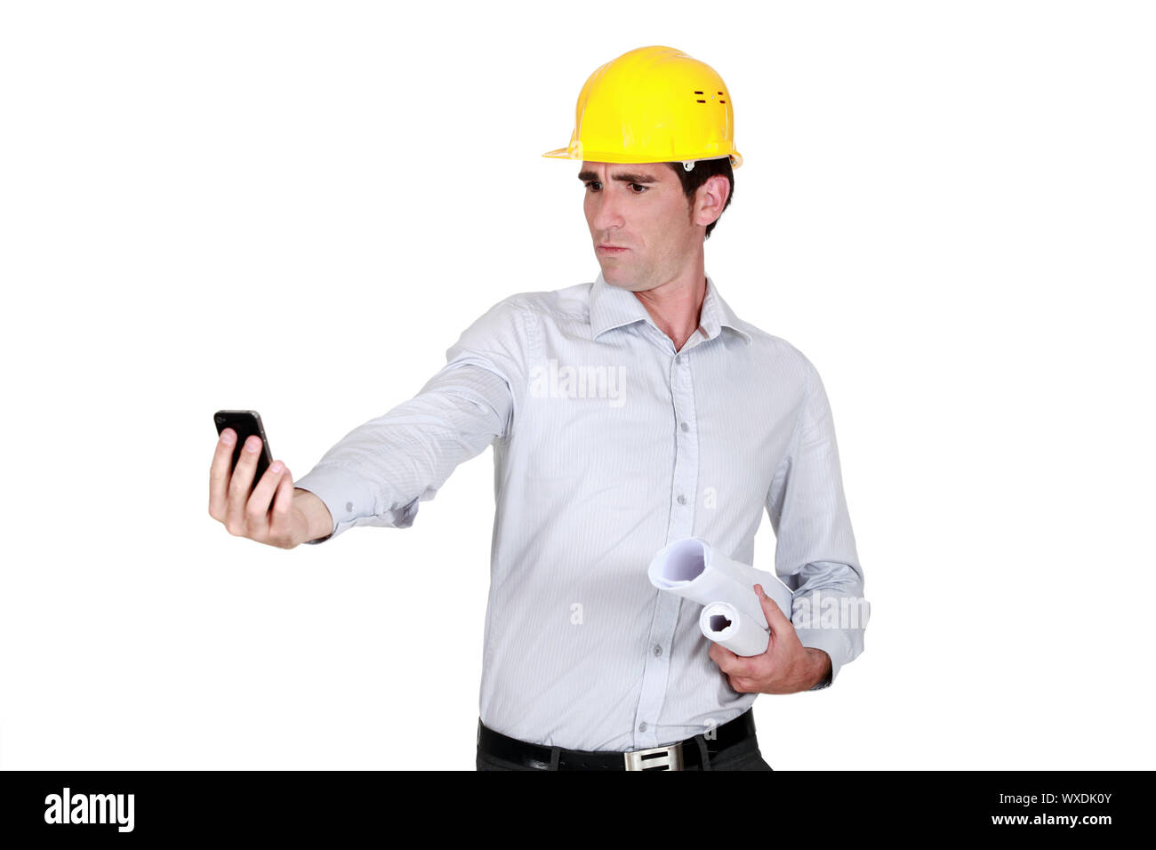 Architect looking at his cellphone Stock Photo - Alamy