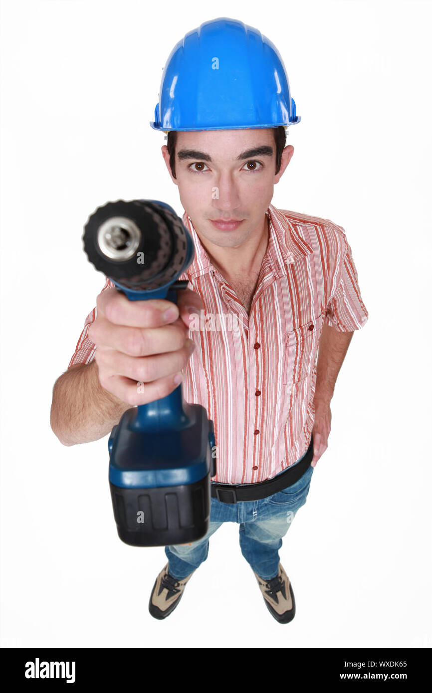 Tradesman holding a power tool Stock Photo - Alamy