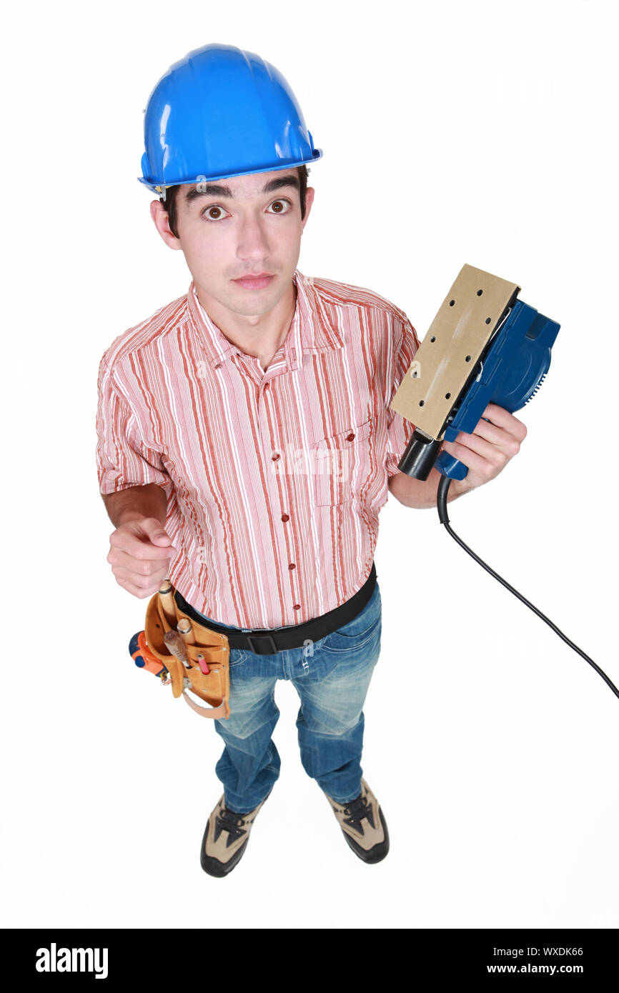 Construction worker holding a sander Stock Photo - Alamy