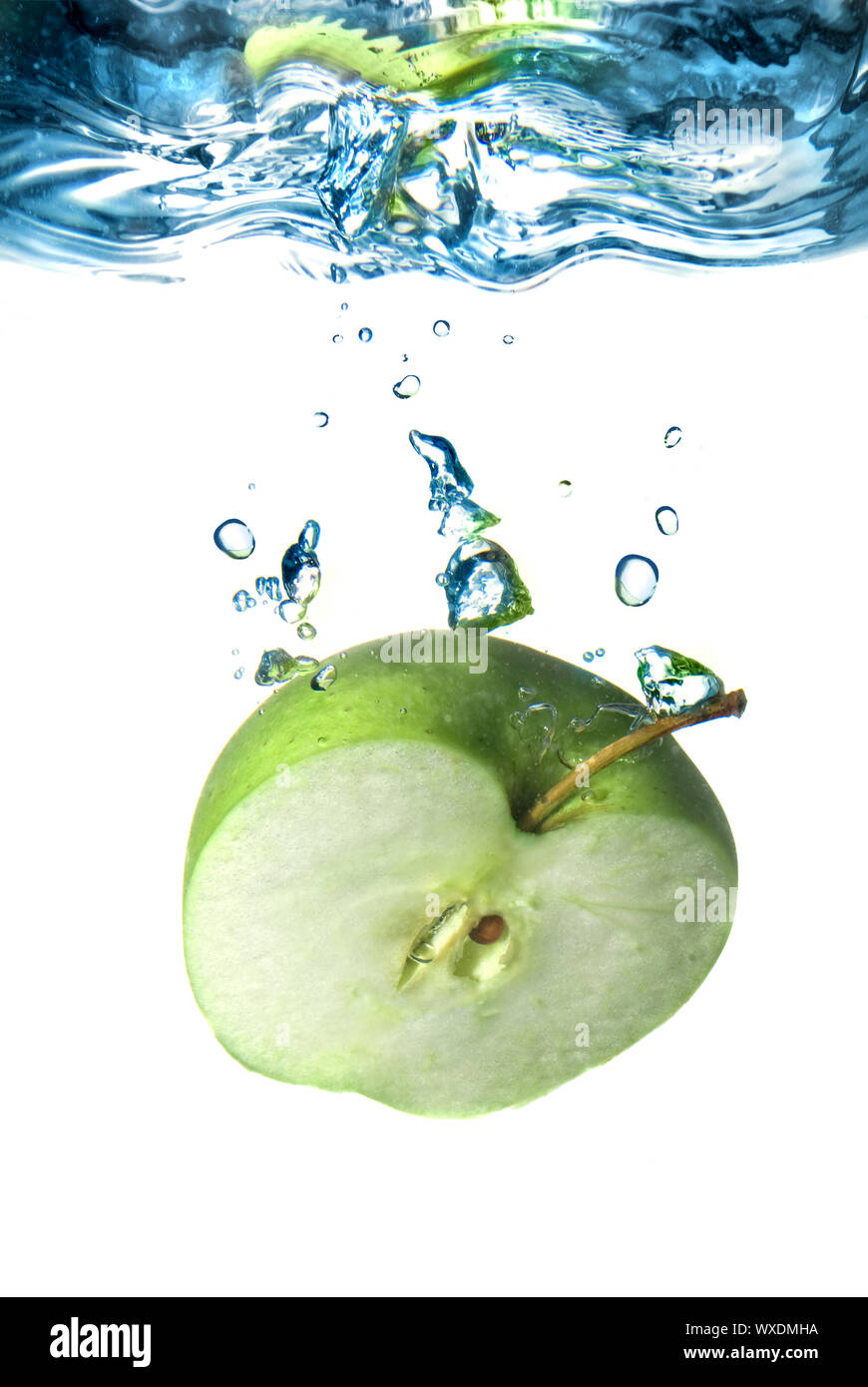 green apple dropped into water with bubbles isolated on white Stock ...