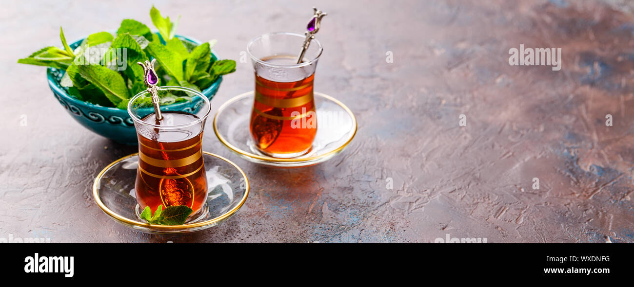 Traditional Turkish arabic dessert and a glass of tea with mint Stock ...