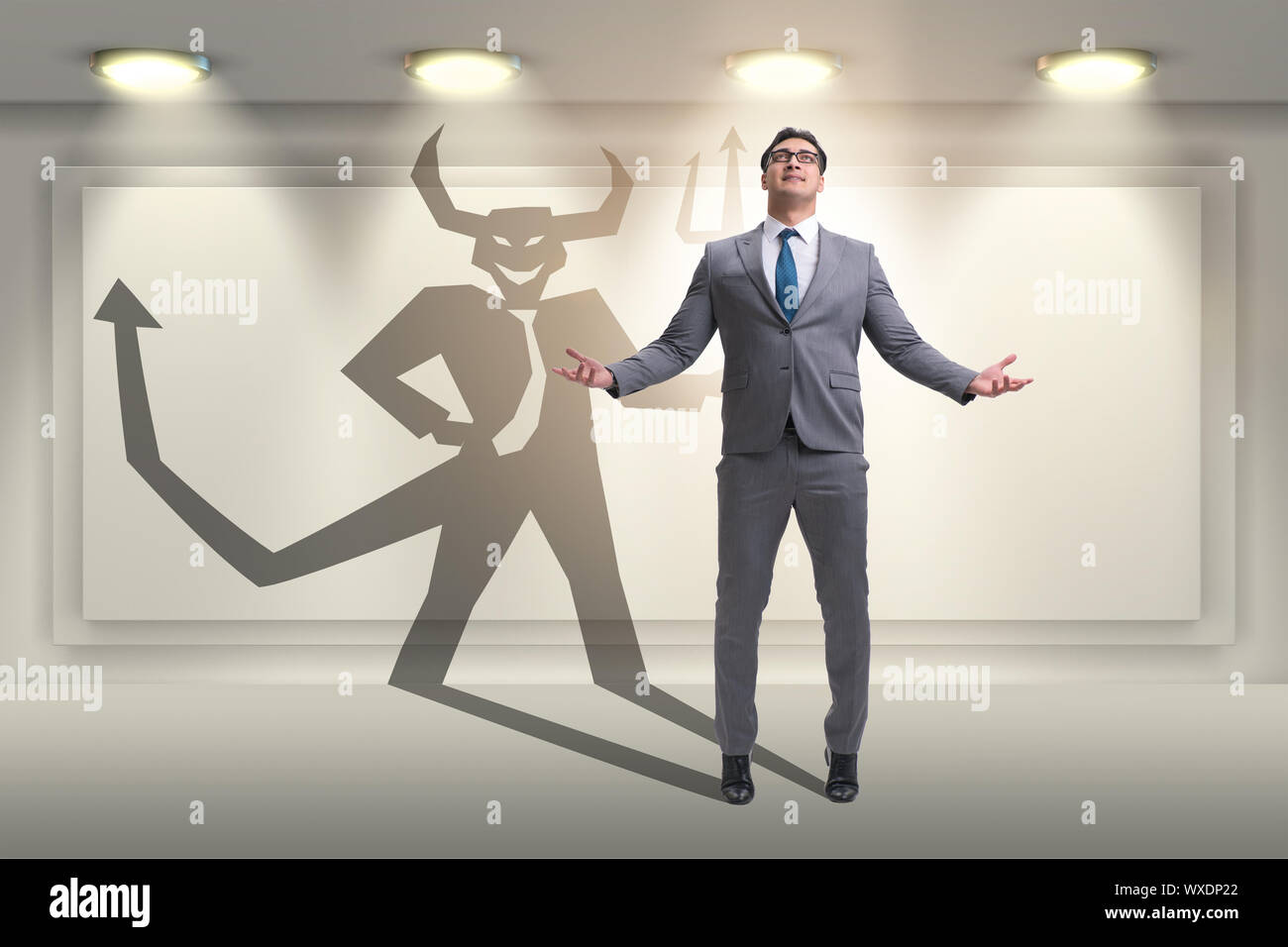 Devil hiding in the businessman - alter ego concept Stock Photo - Alamy