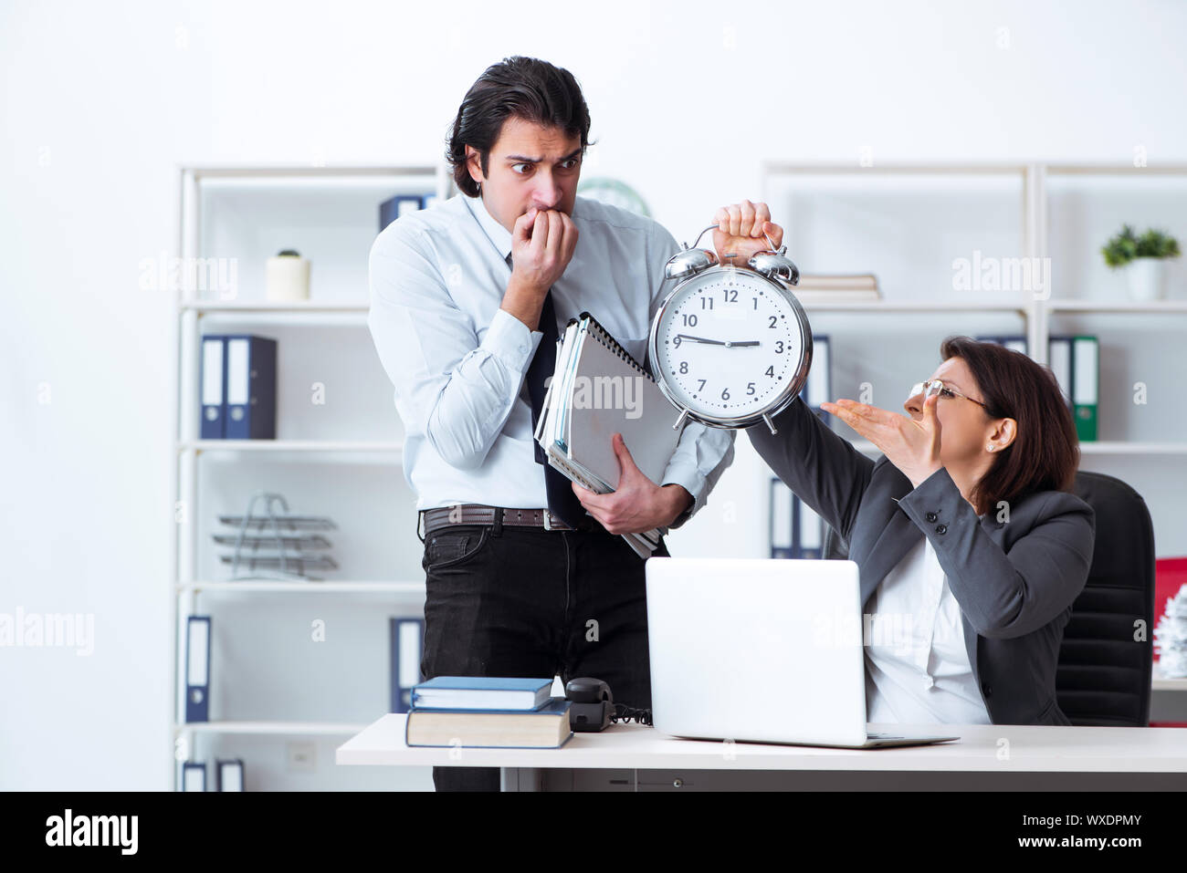 Old female boss and young male employee in the office Stock Photo - Alamy
