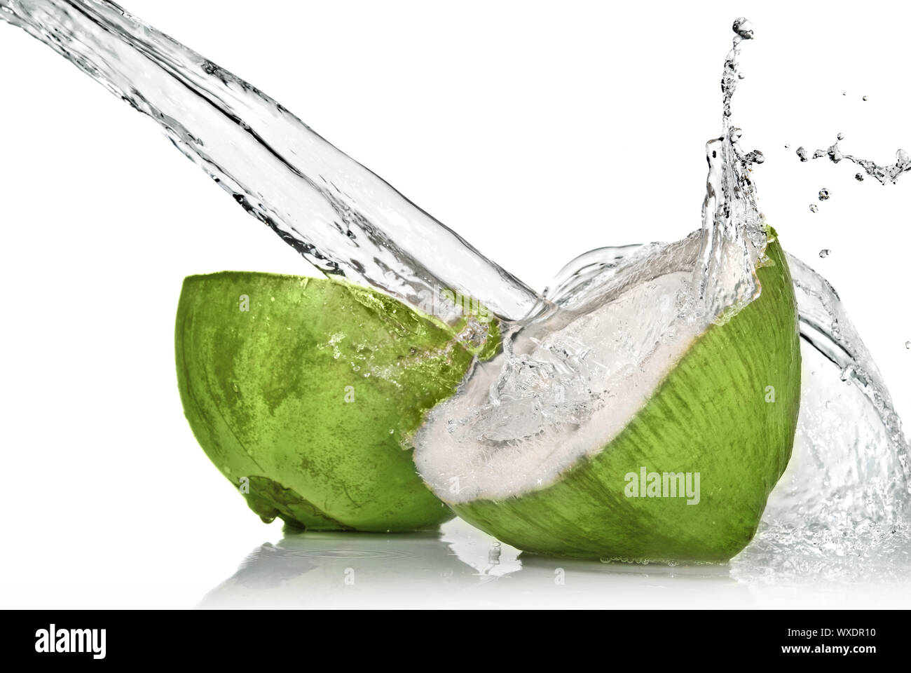 Green coconut with water splash isolated on white Stock Photo - Alamy