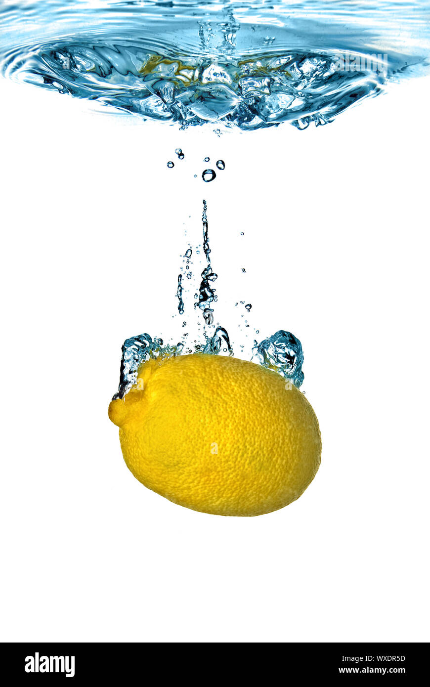 Fresh lemon dropped into water with bubbles isolated on white Stock ...