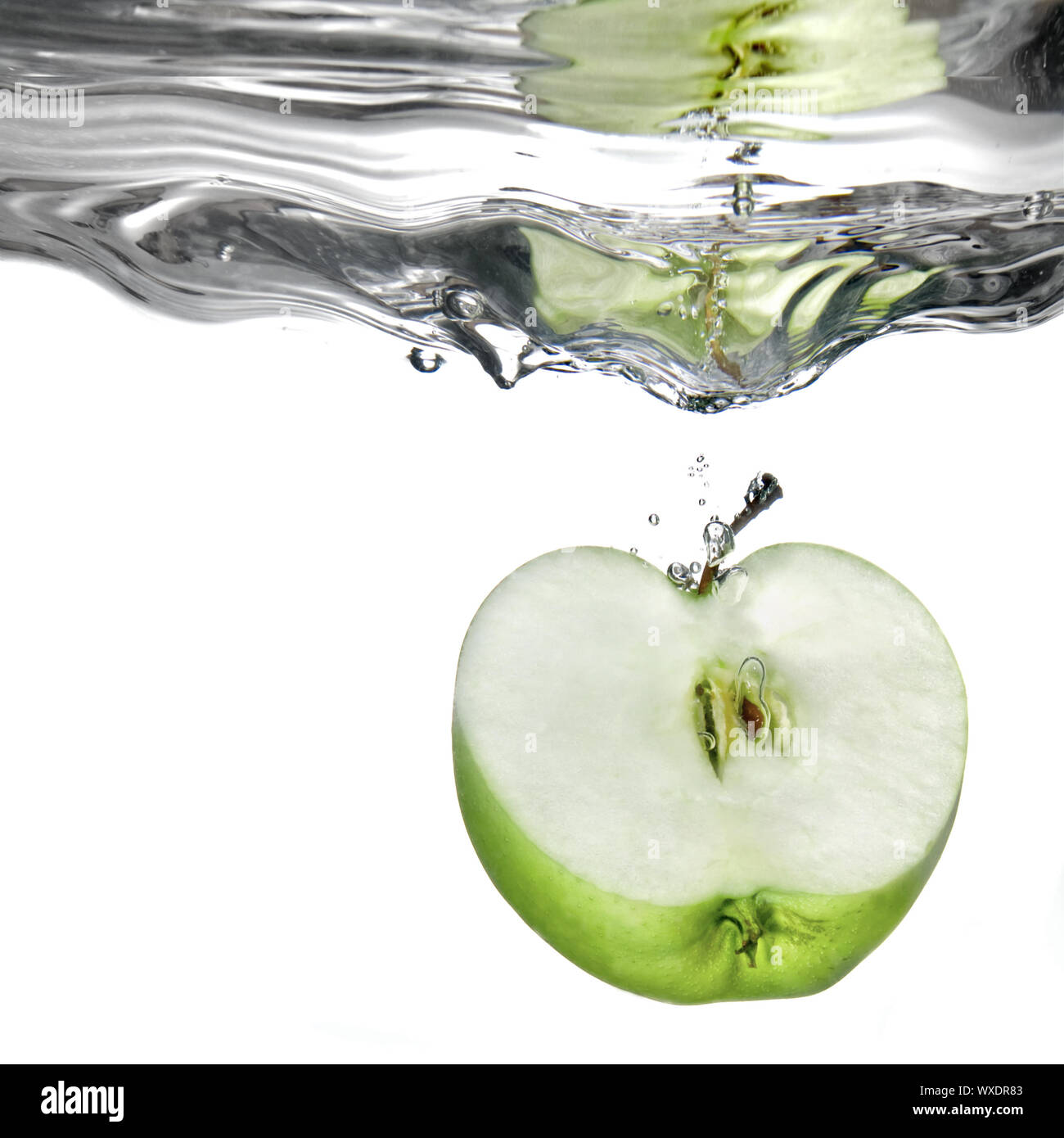 green apple dropped into water with splash isolated on white Stock ...