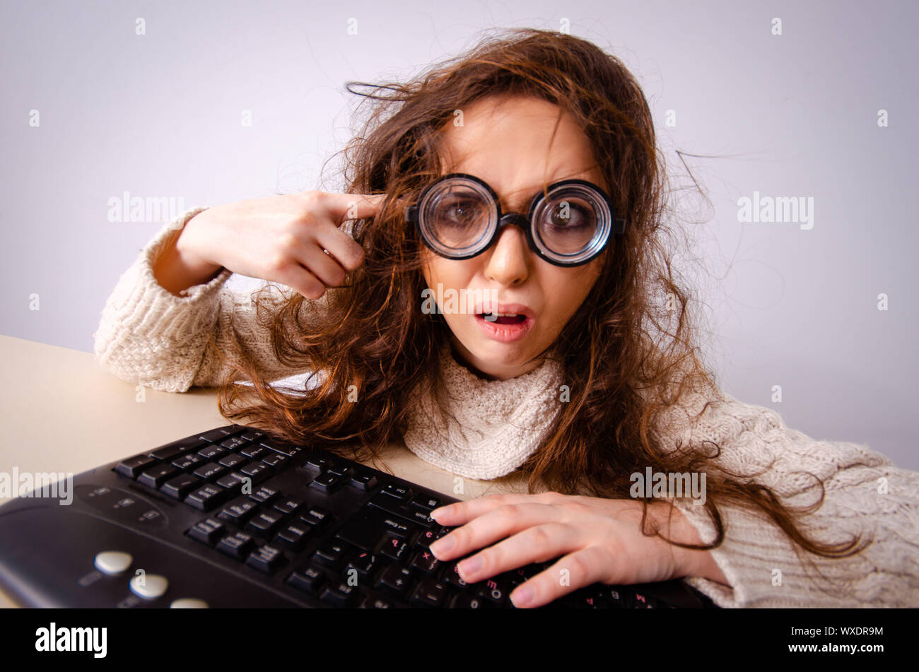 Funny nerd girl working on computer Stock Photo - Alamy
