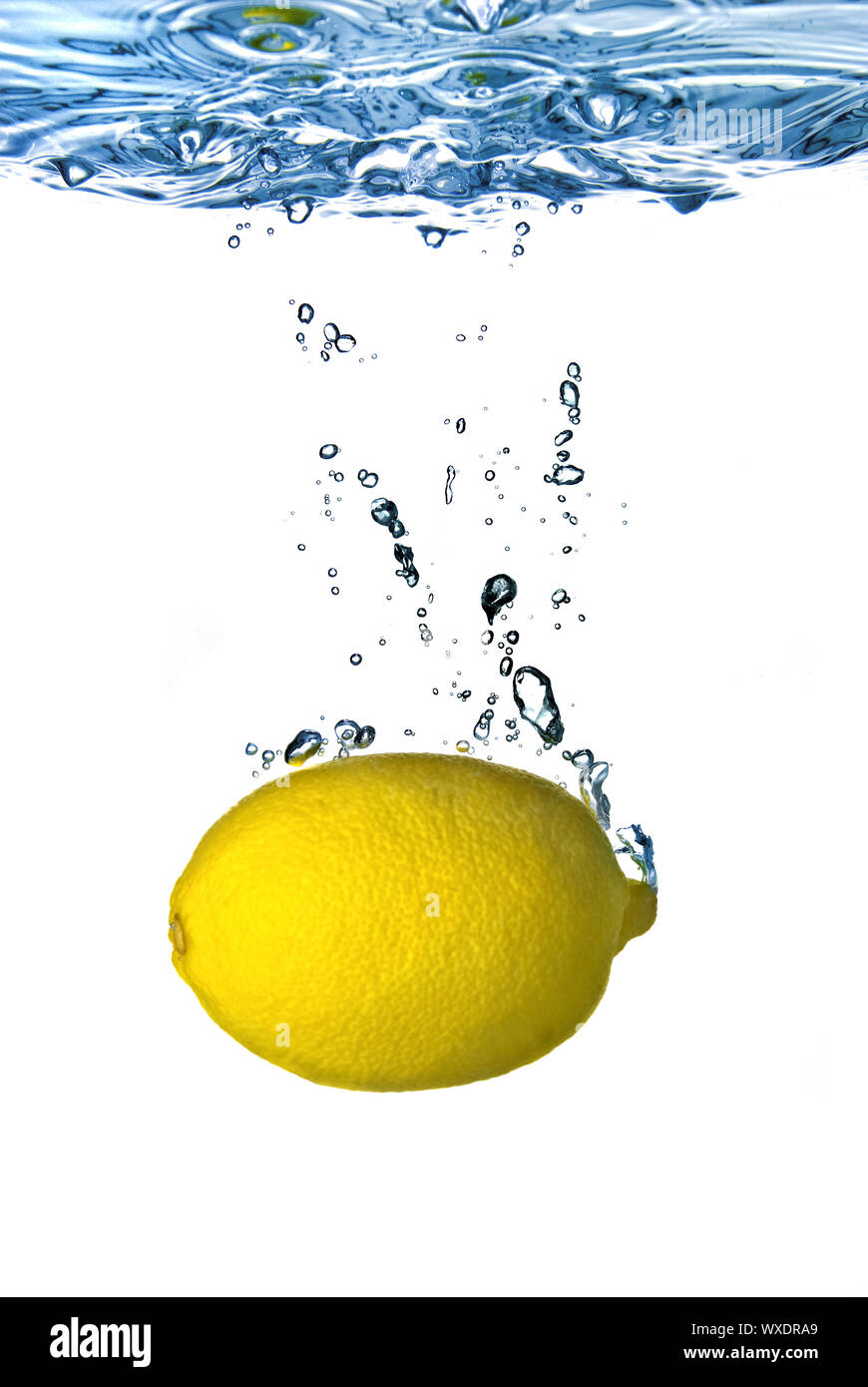 Fresh lemon dropped into water with bubbles isolated on white Stock ...