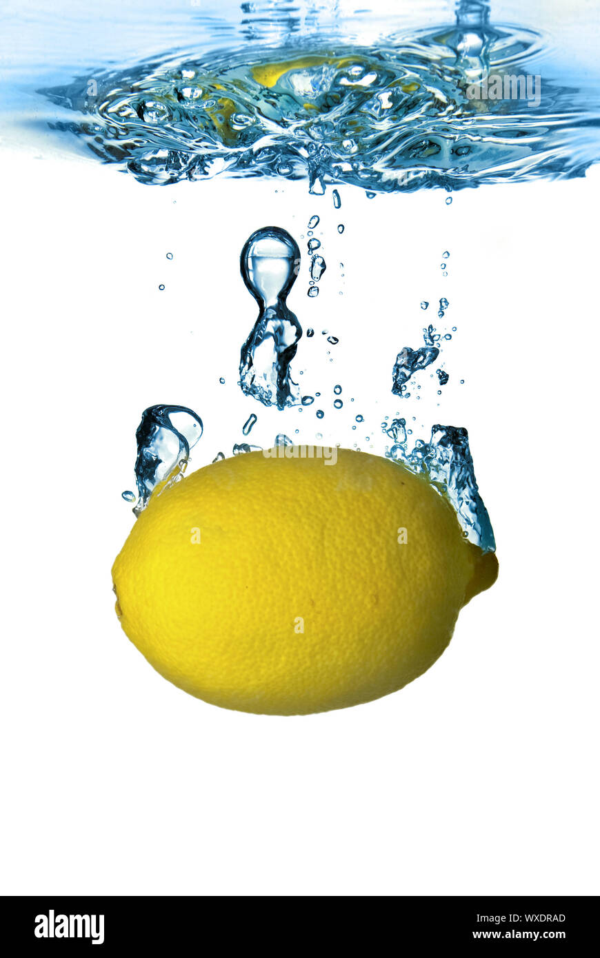 Fresh lemon dropped into water with bubbles isolated on white Stock ...
