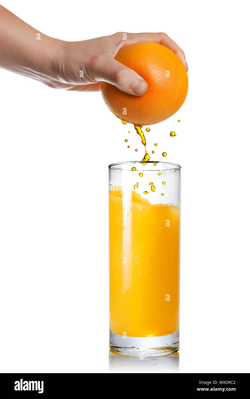 squeezing orange juice pouring into glass isolated on white Stock Photo ...
