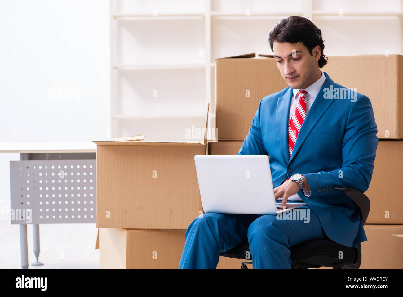 Young handsome businessman moving to new workplace Stock Photo - Alamy