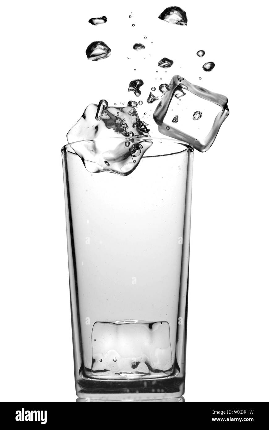 ice cubes dropped into glass with bubbles isolated on white Stock Photo ...