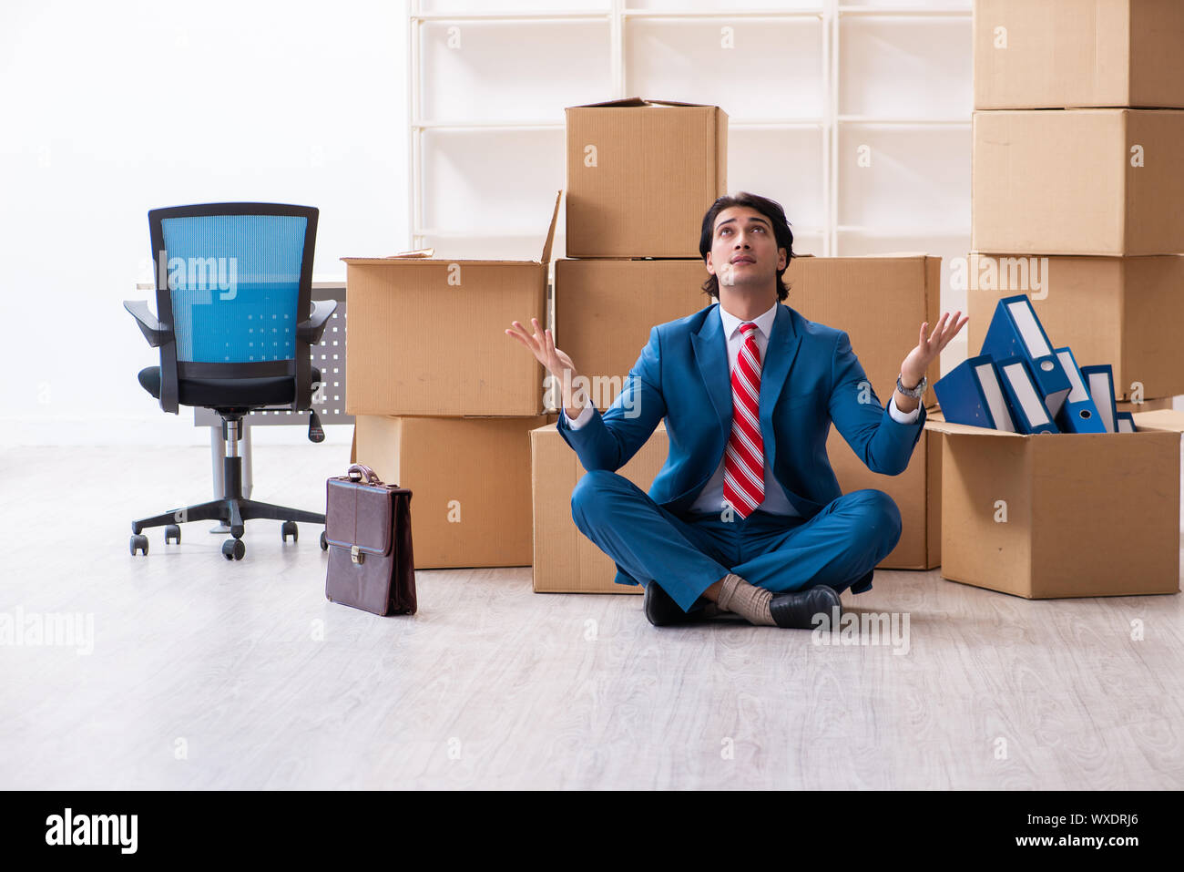 Young handsome businessman moving to new workplace Stock Photo - Alamy