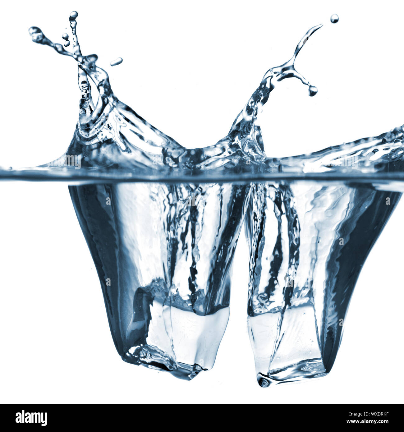ice cubes dropped into water with splash isolated on white Stock Photo - Alamy