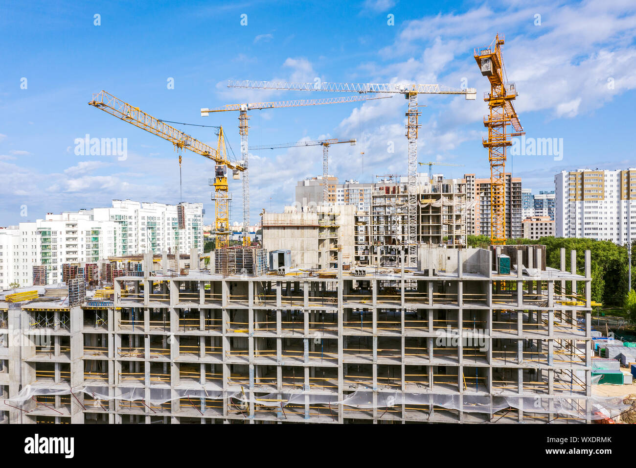 aerial panoramic view of city construction site with tower cranes ...