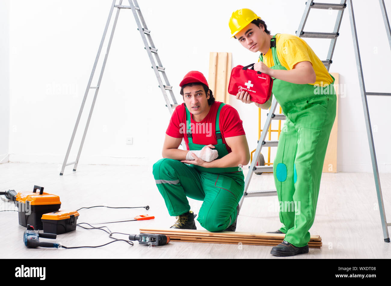 Injured worker and his workmate Stock Photo - Alamy