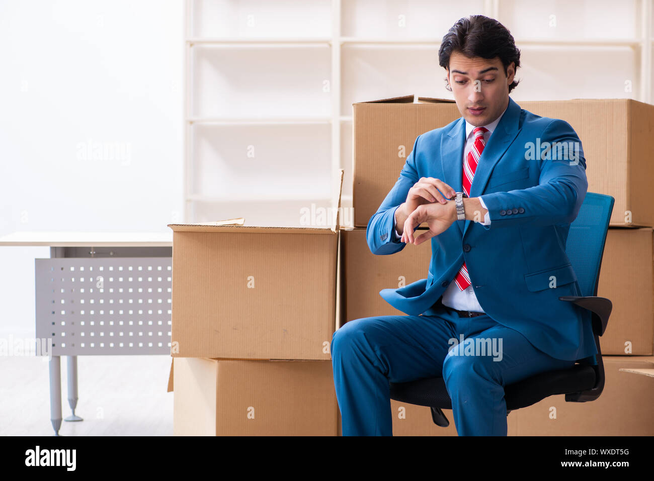 Young handsome businessman moving to new workplace Stock Photo - Alamy