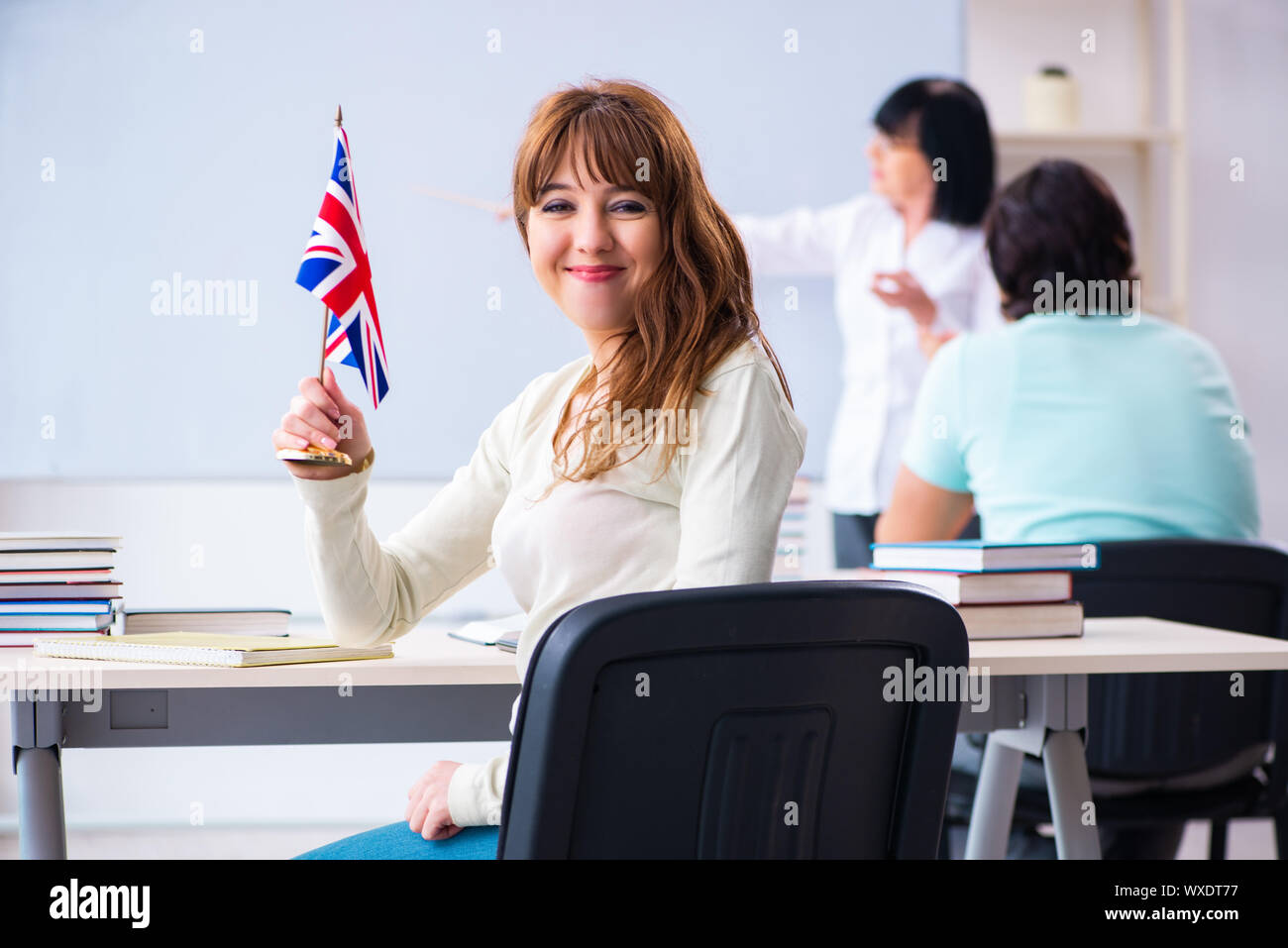 Old female english teacher and students in the classroom Stock Photo ...