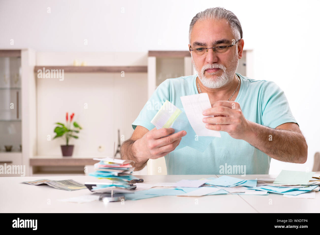 White bearded old man in budget planning concept Stock Photo - Alamy