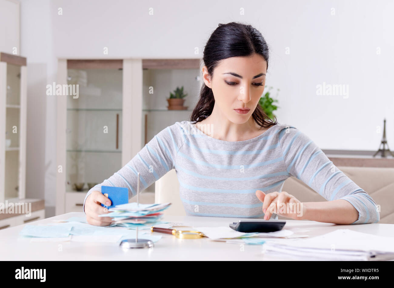 Young woman in budget planning concept Stock Photo - Alamy