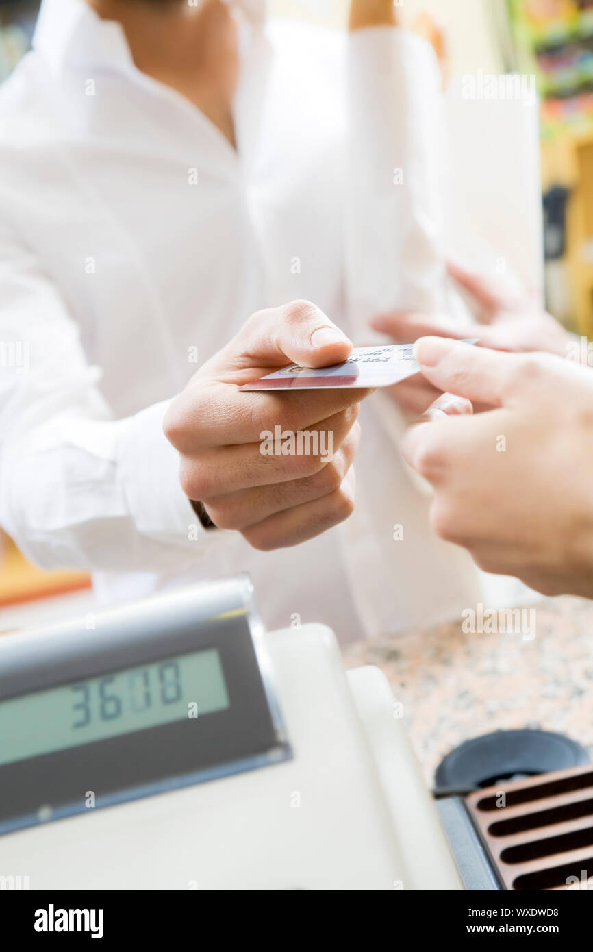 man doing shopping in a grocery store and paying by credit card Stock ...