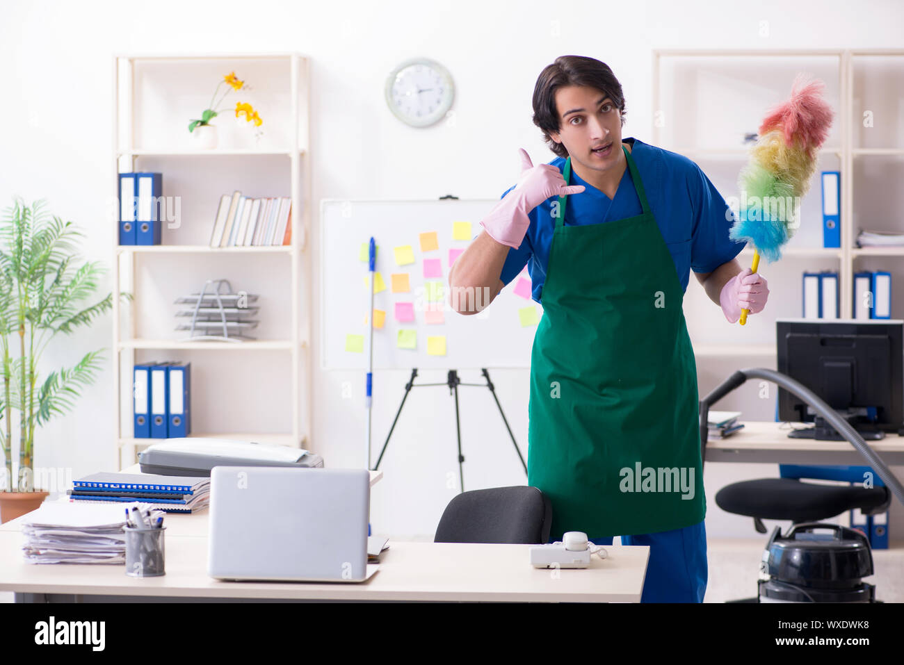 Male handsome professional cleaner working in the office Stock Photo ...