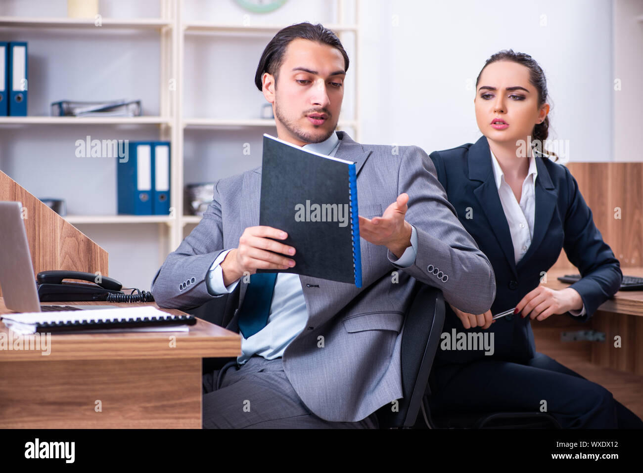 Two employees working in the office Stock Photo - Alamy