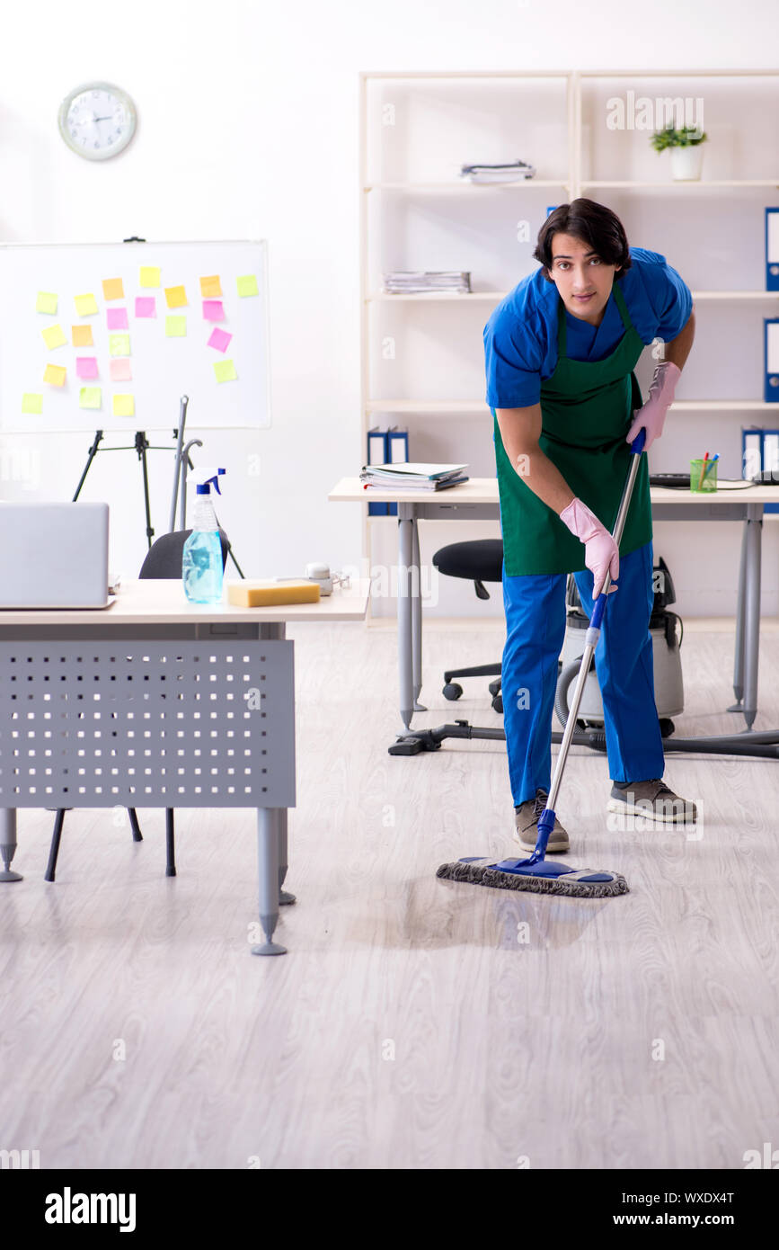 Male handsome professional cleaner working in the office Stock Photo ...