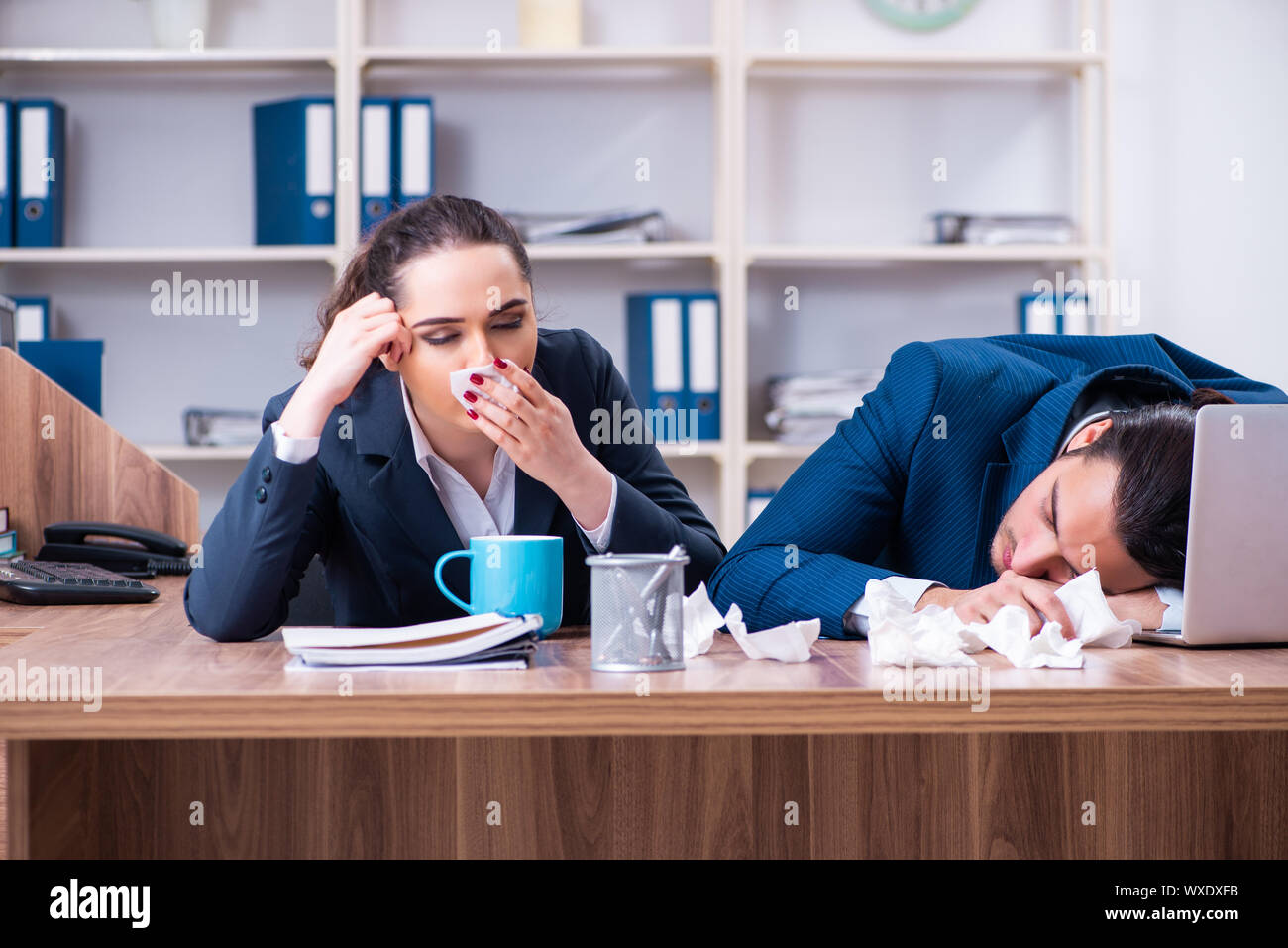 Two employees suffering at workplace Stock Photo - Alamy