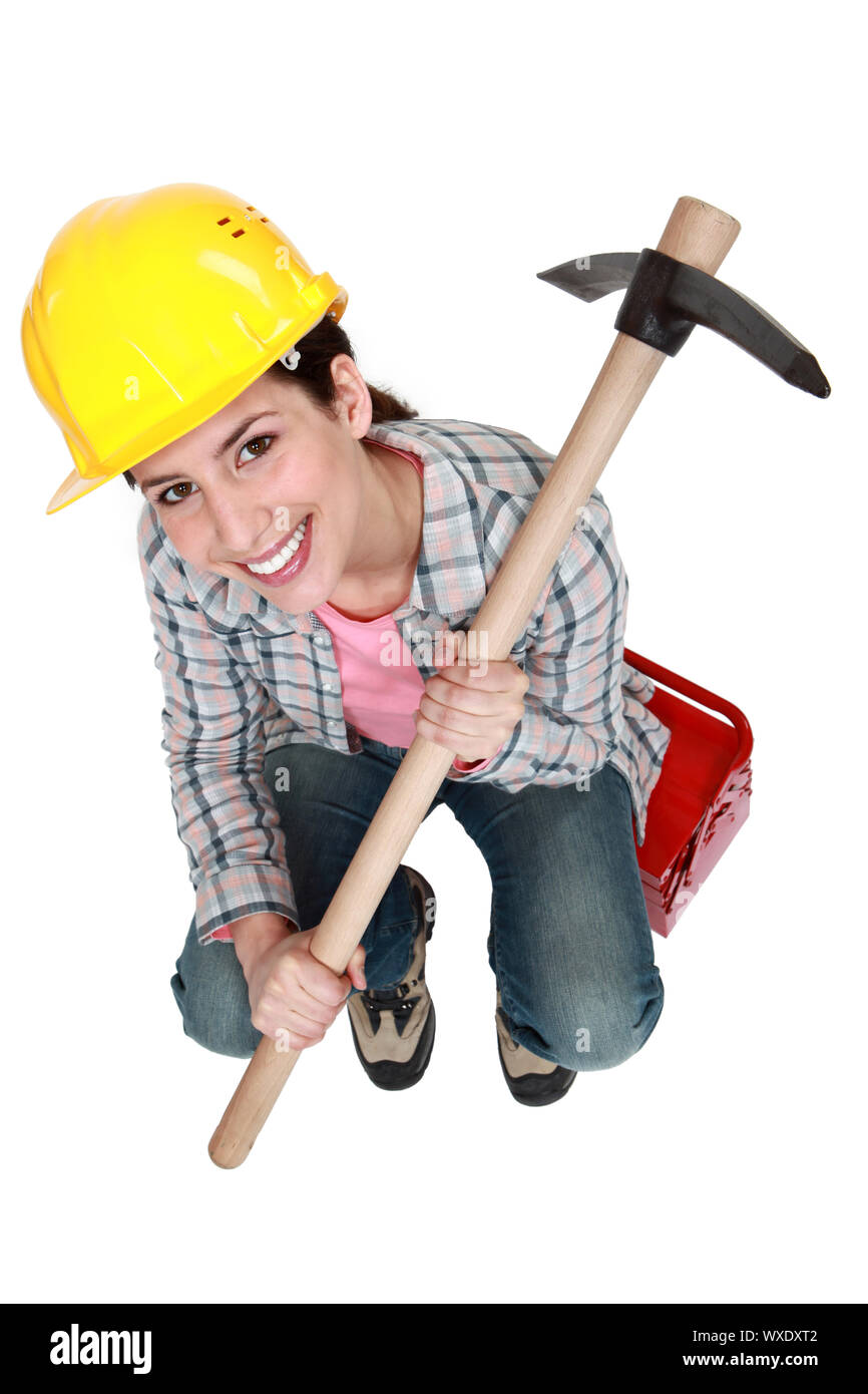 Woman holding pick-axe Stock Photo - Alamy