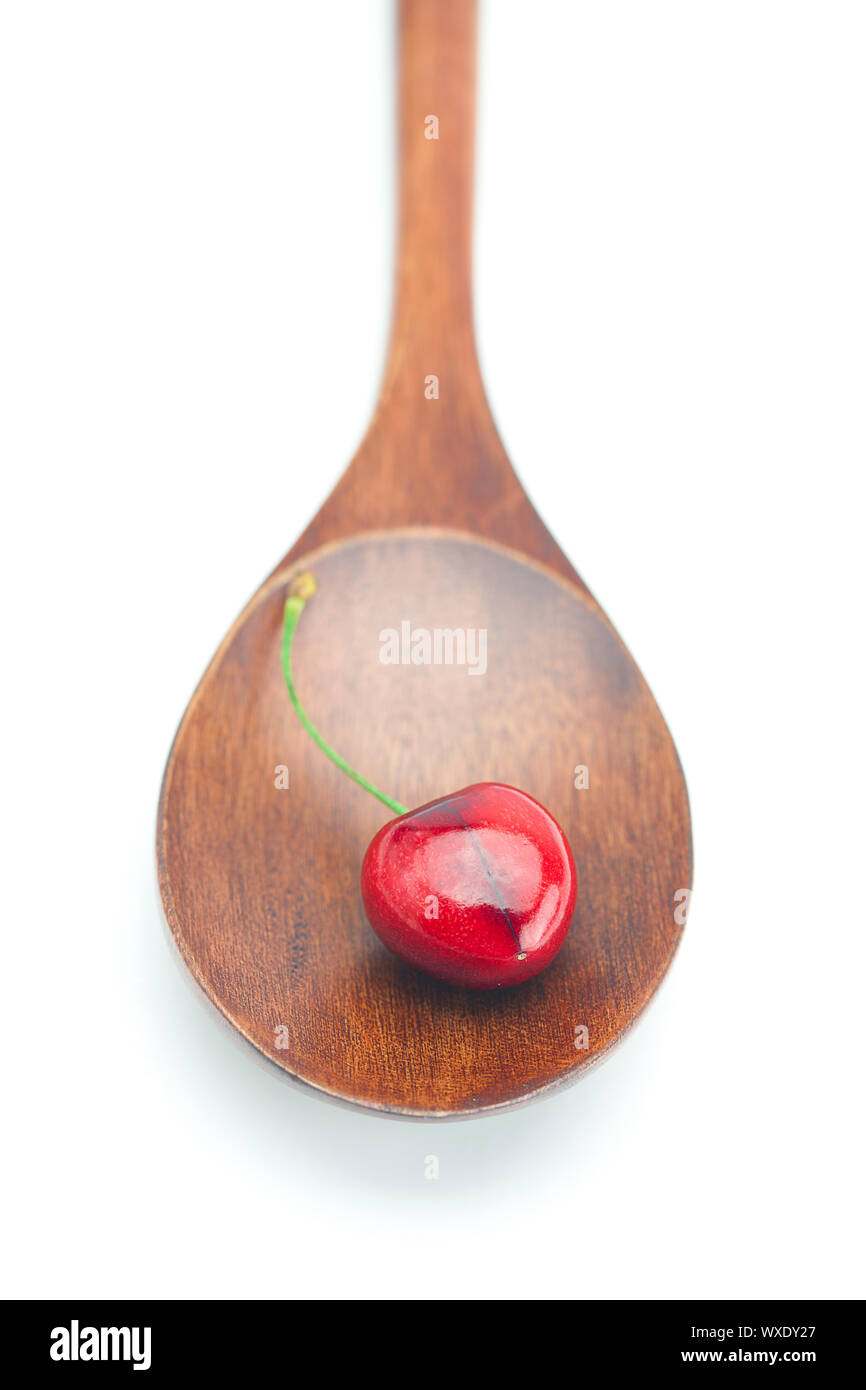 wooden spoon and cherry isolated on white Stock Photo - Alamy